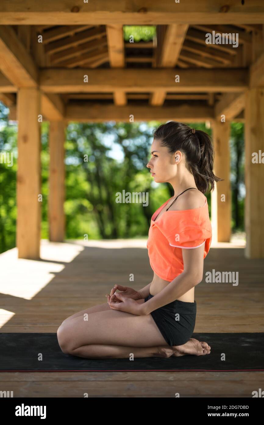 Girl sits on the heels Stock Photo - Alamy