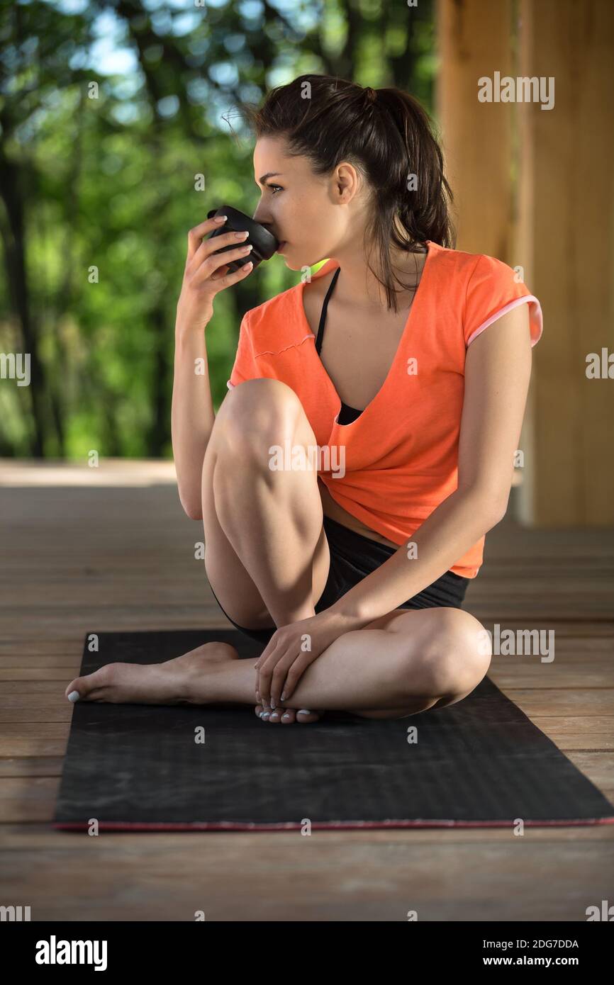 Yoga girl with cup Stock Photo - Alamy