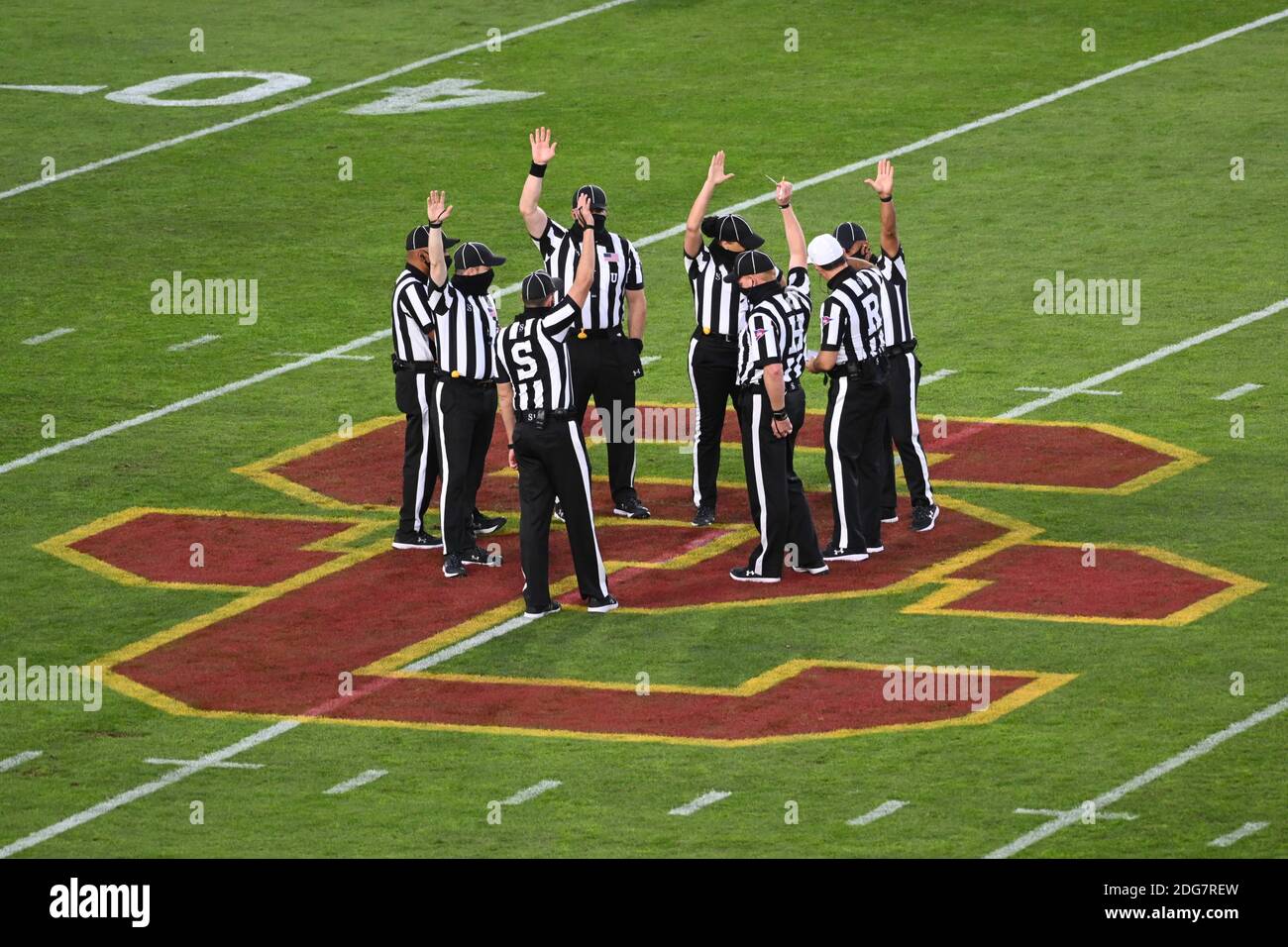 PAC-12 referees stand on the 50-yard line before an NCAA football game ...