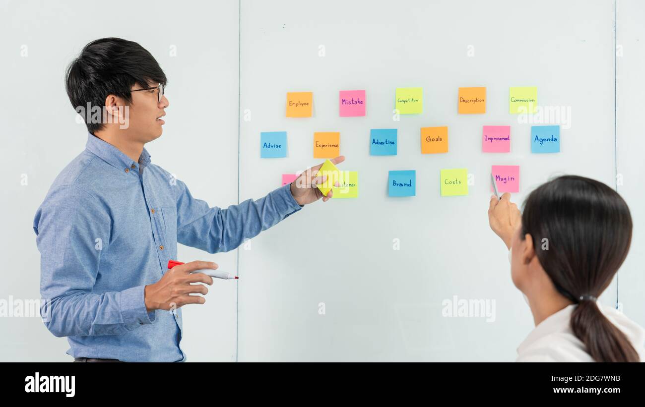 business teamwork in meeting and adhesive stick note on mirror board ...