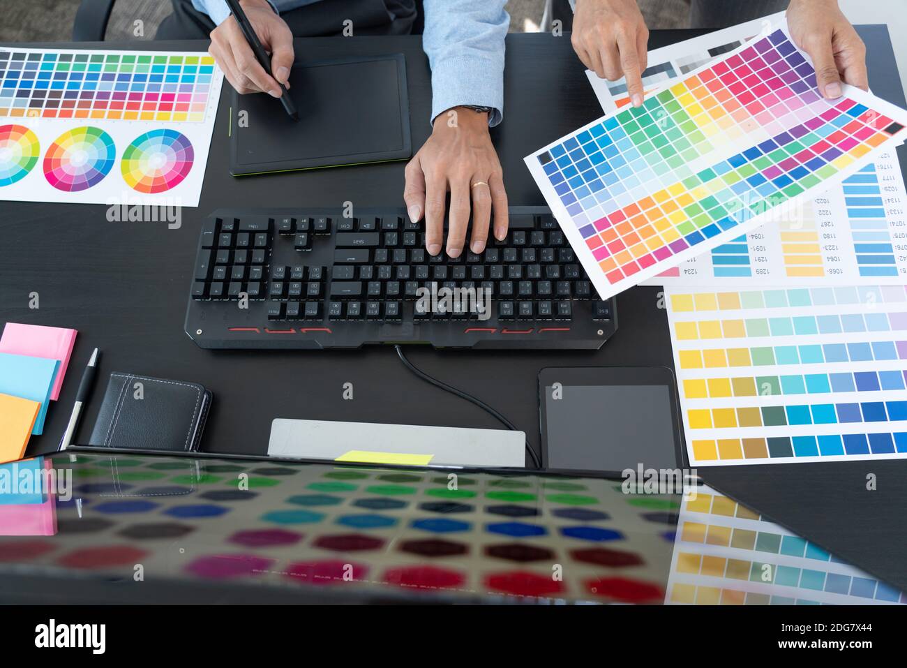 graphic designer team working on web design using color swatches ...