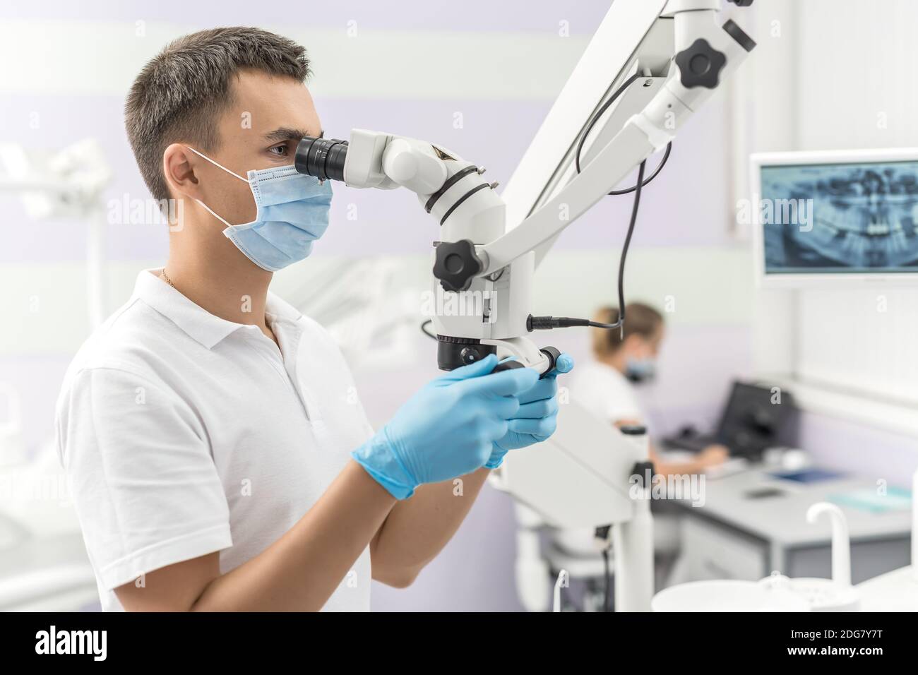 Dentist using dental microscope Stock Photo - Alamy