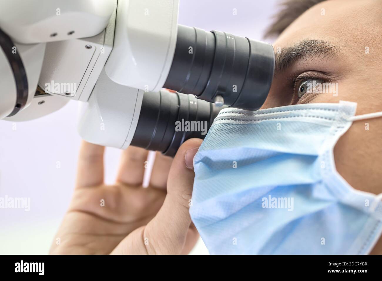 Doctor using a dental microscope Stock Photo - Alamy