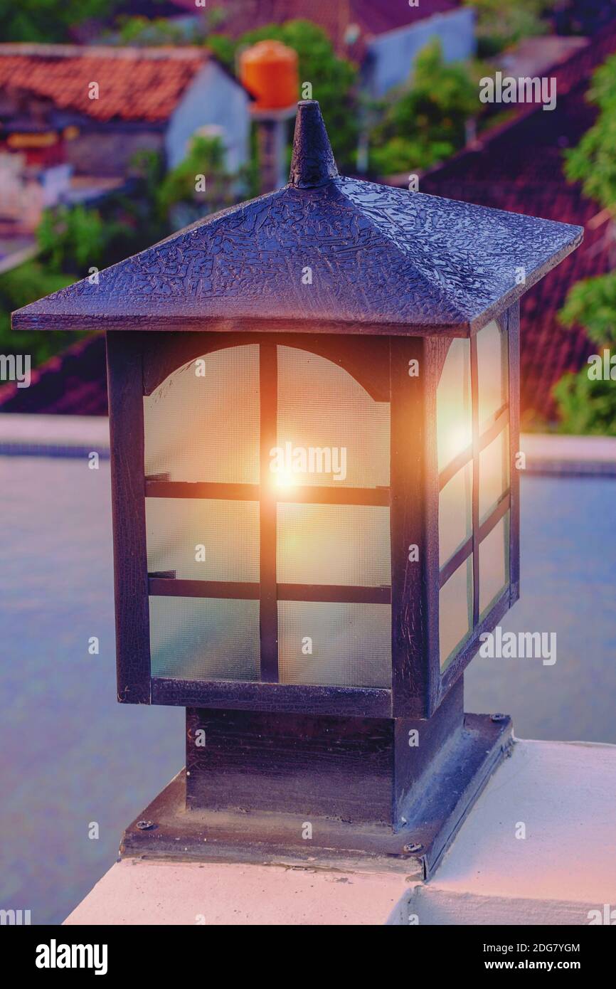 Evening outdoor illumination - glowing street lamp with cosy warm light ...