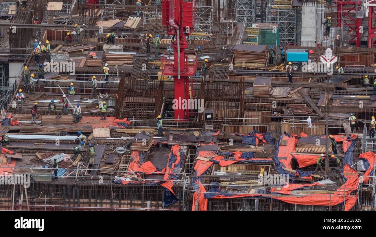 Builders working on construction site Stock Photo - Alamy