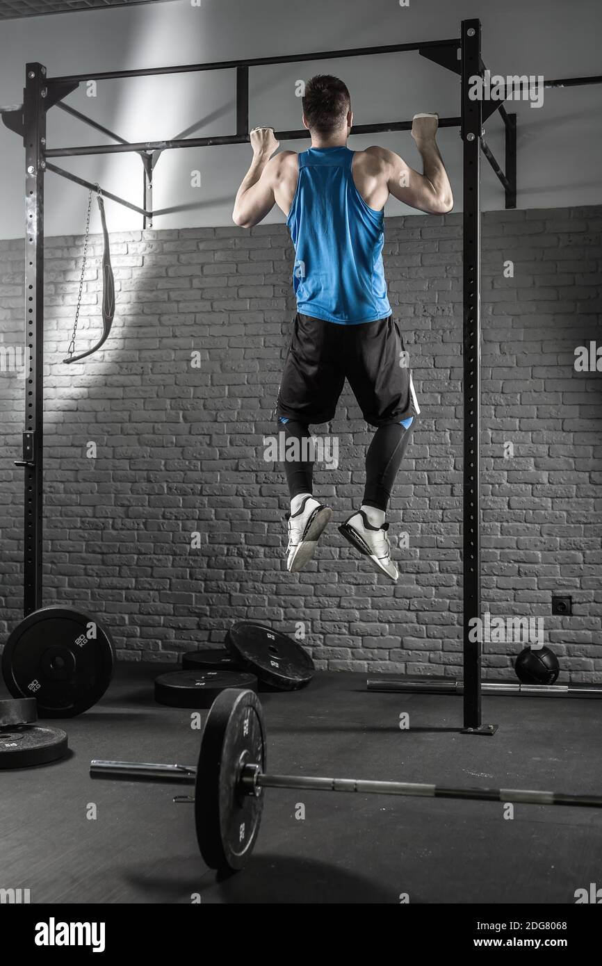 Young man makes pull-up workout Stock Photo - Alamy