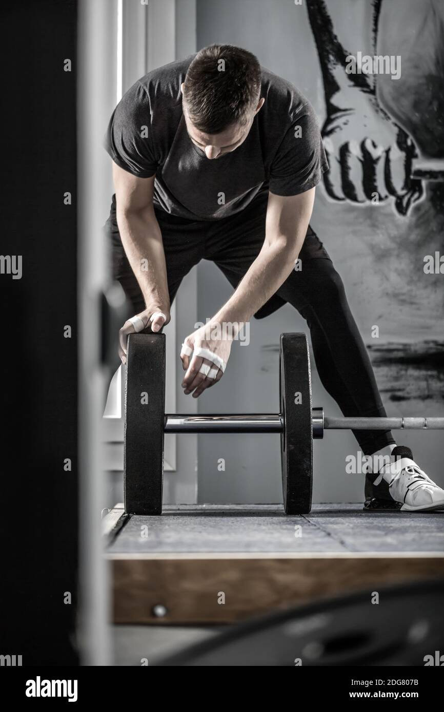 Preparation of barbell in gym Stock Photo - Alamy