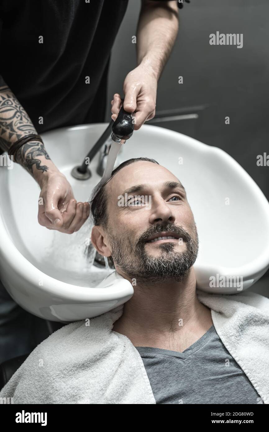 Washing head in barbershop Stock Photo - Alamy