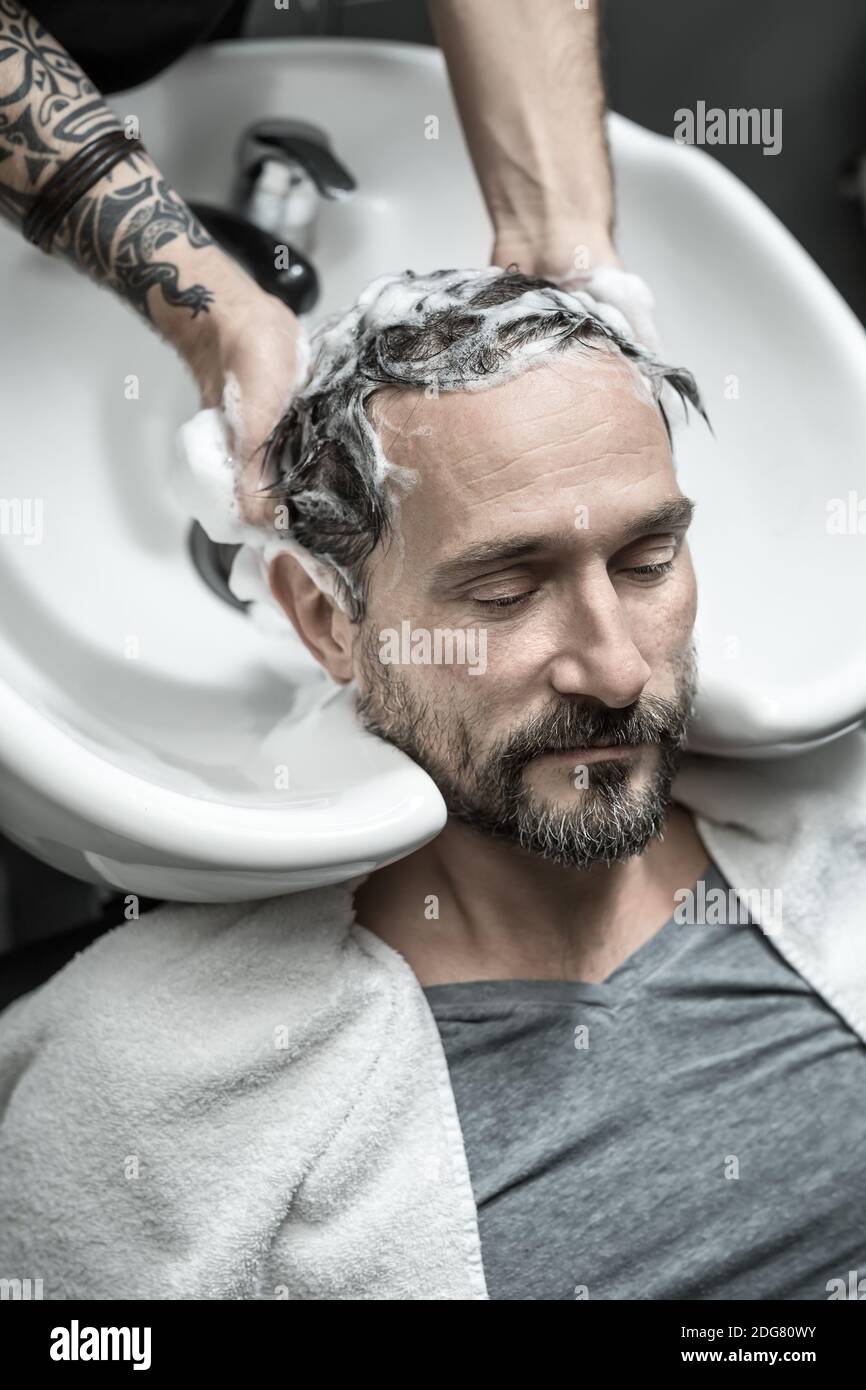 Washing head in barbershop Stock Photo - Alamy