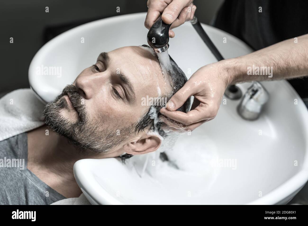 Washing head in barbershop Stock Photo - Alamy