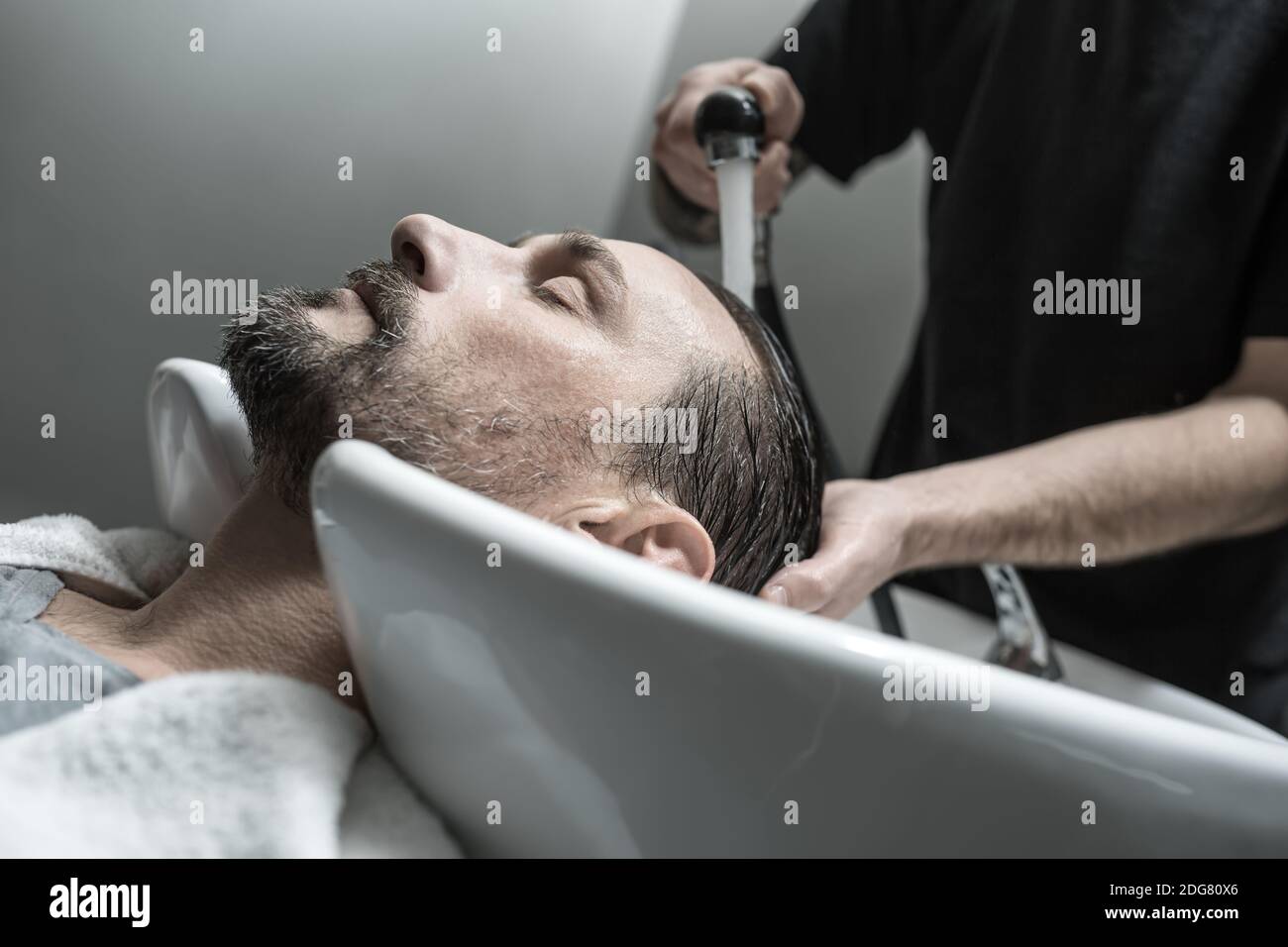 Washing head in barbershop Stock Photo - Alamy