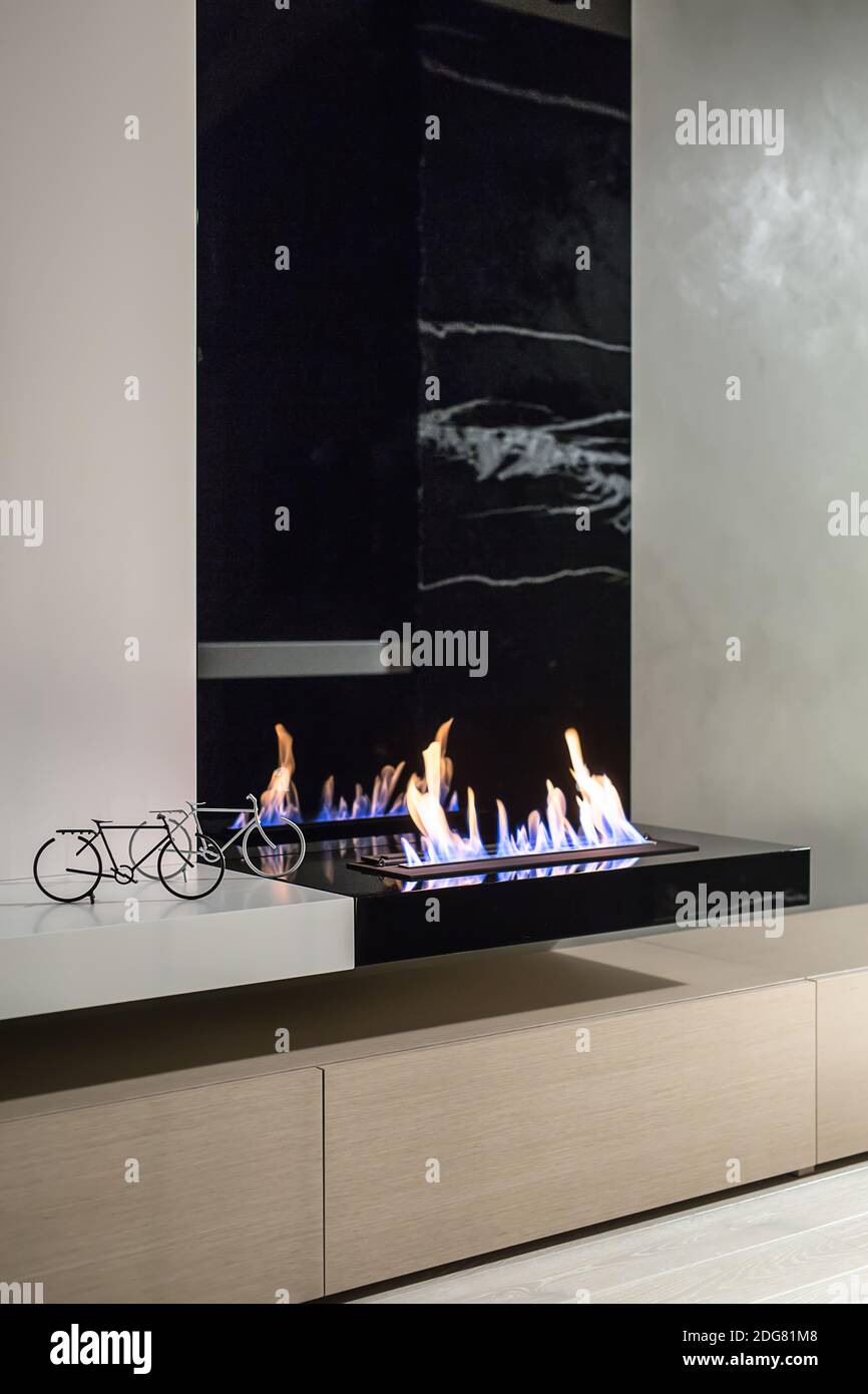 Burning fireplace in modern interior Stock Photo - Alamy
