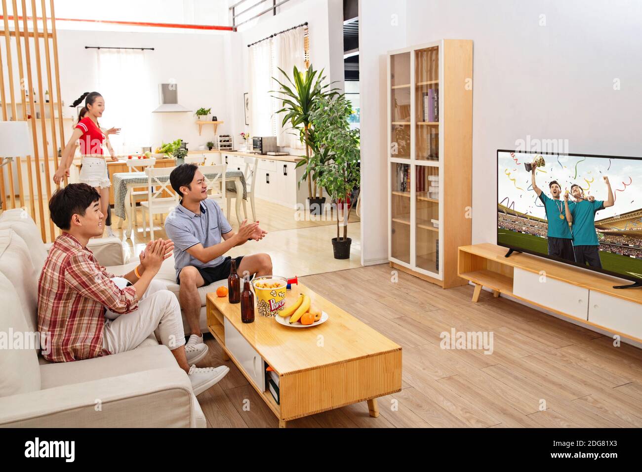 Happy friends see a ball game at home Stock Photo - Alamy