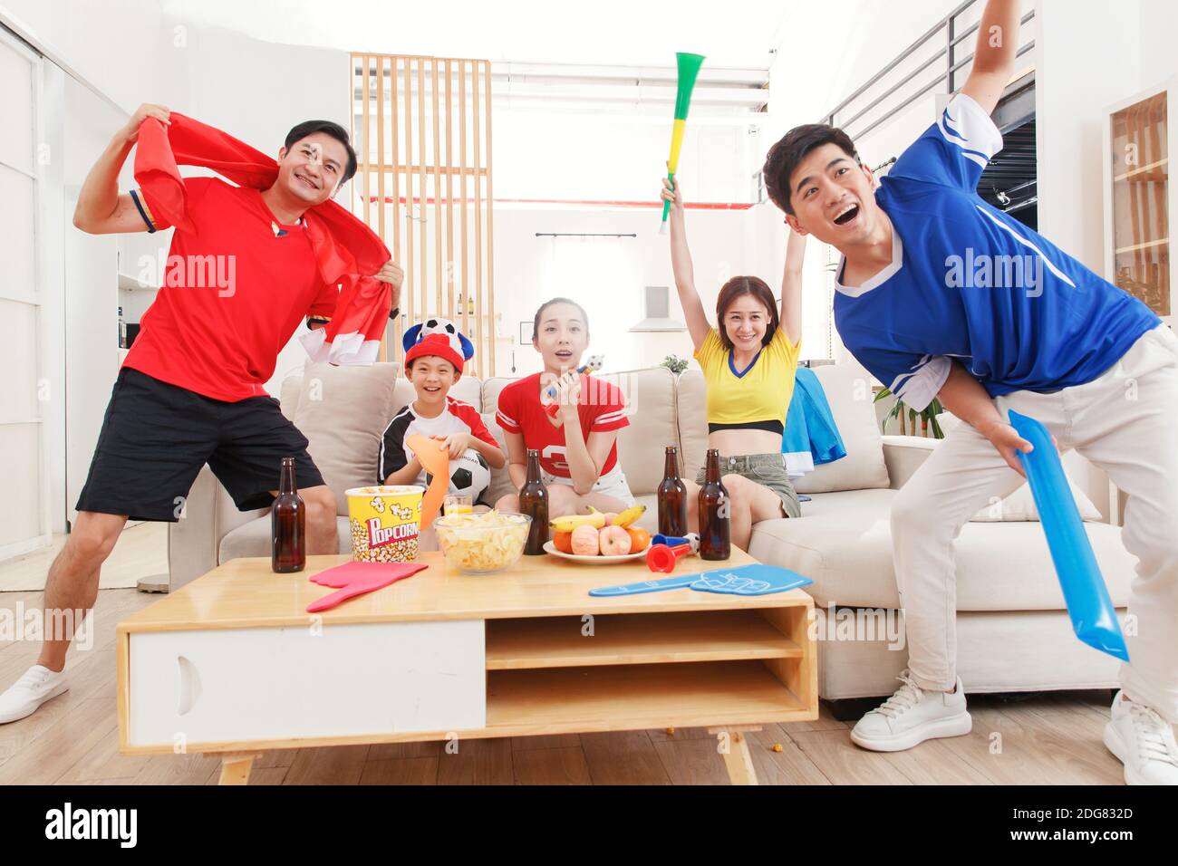 Happy young friend to watch the game at home Stock Photo - Alamy