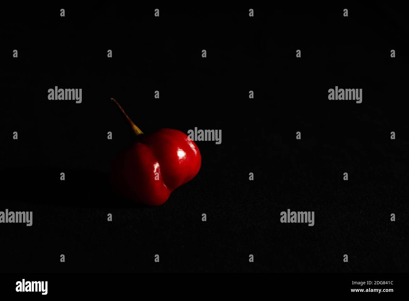 Red chilli peppers on black background Stock Photo - Alamy