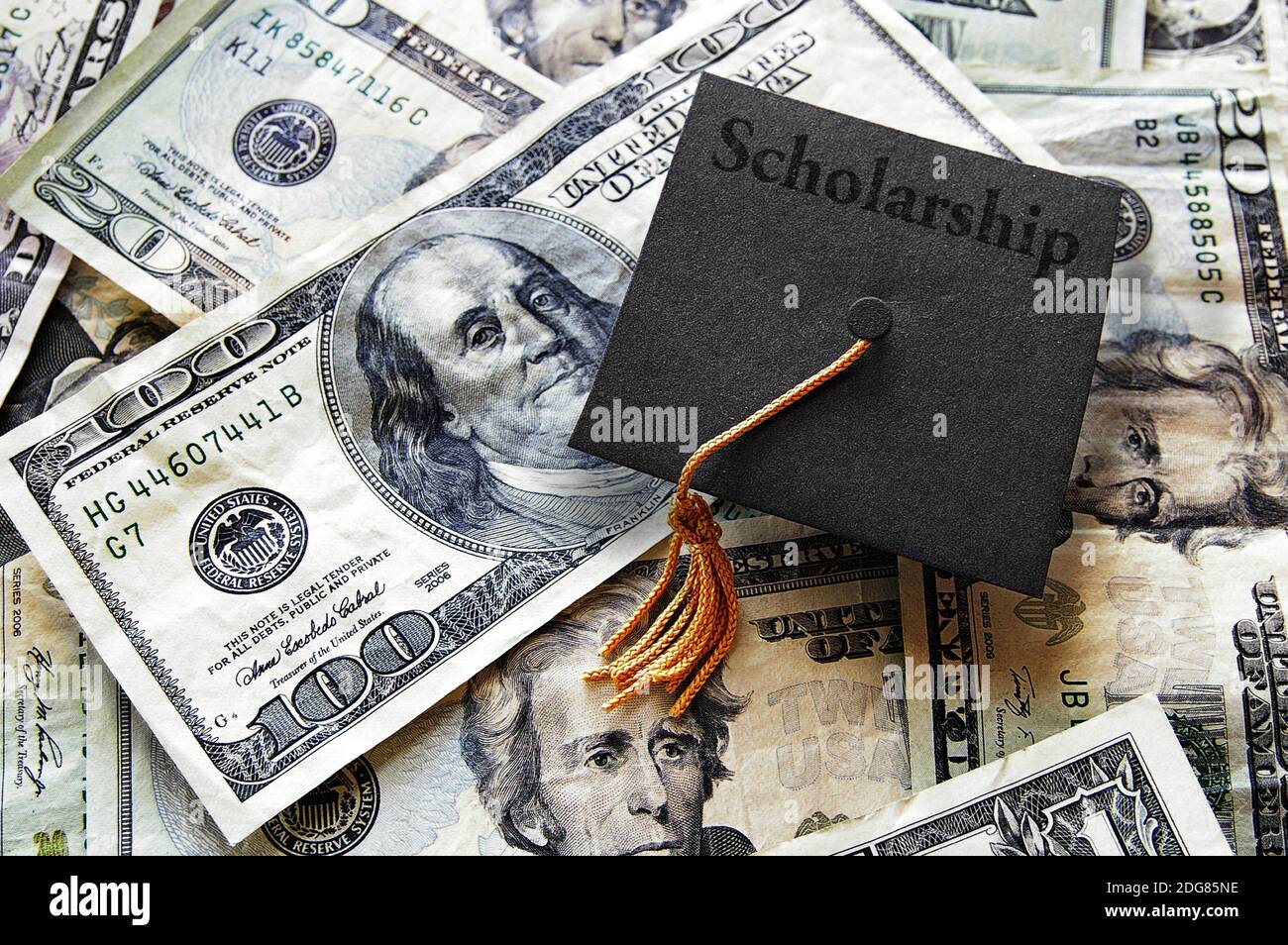Scholarship grad cap on cash Stock Photo - Alamy