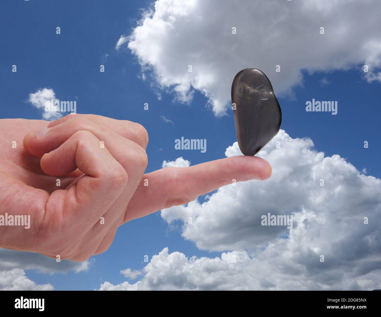 Finger balance and blue sky Stock Photo - Alamy
