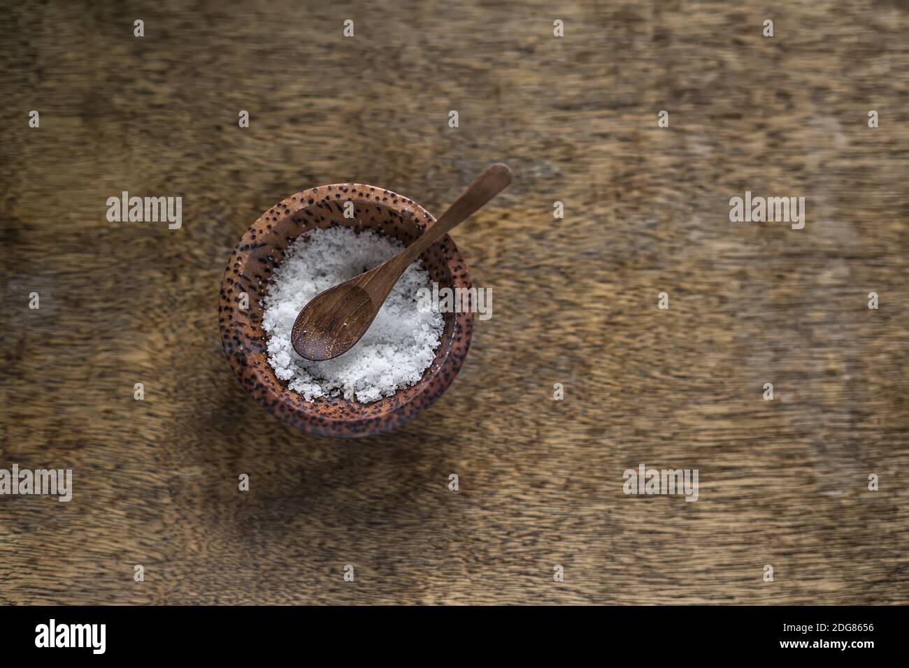 Coconut plate with salt and spoon Stock Photo - Alamy