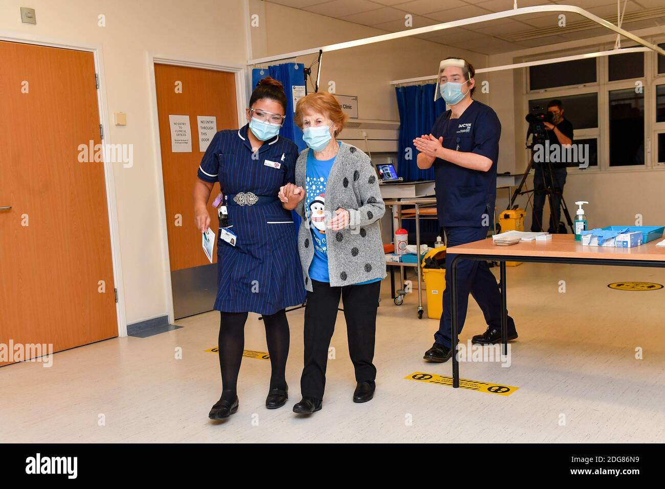 Margaret Keenan, 90, walks with nurse May Parsons (left) after becoming ...