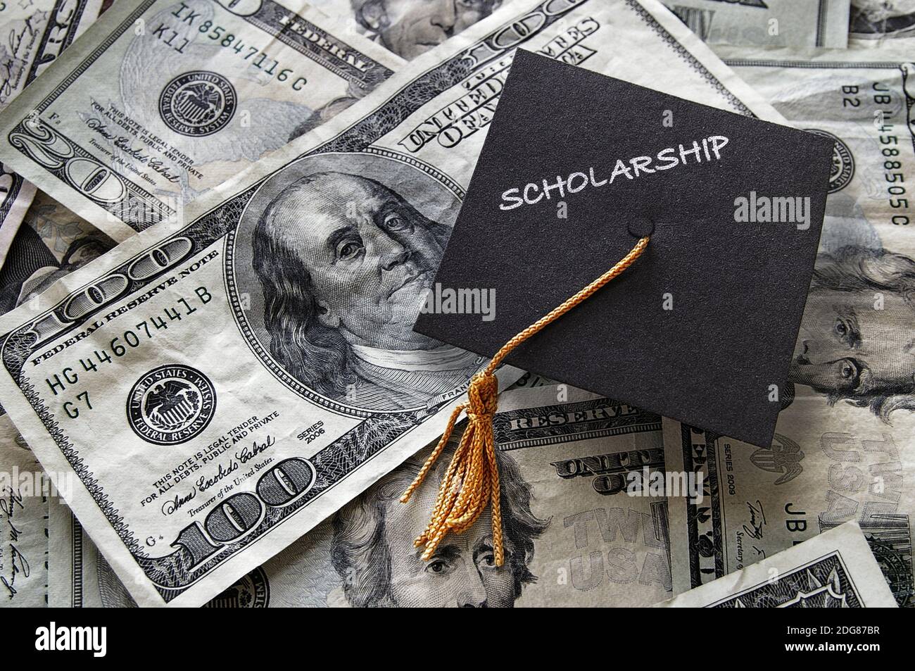Scholarship graduation cap on cash Stock Photo - Alamy