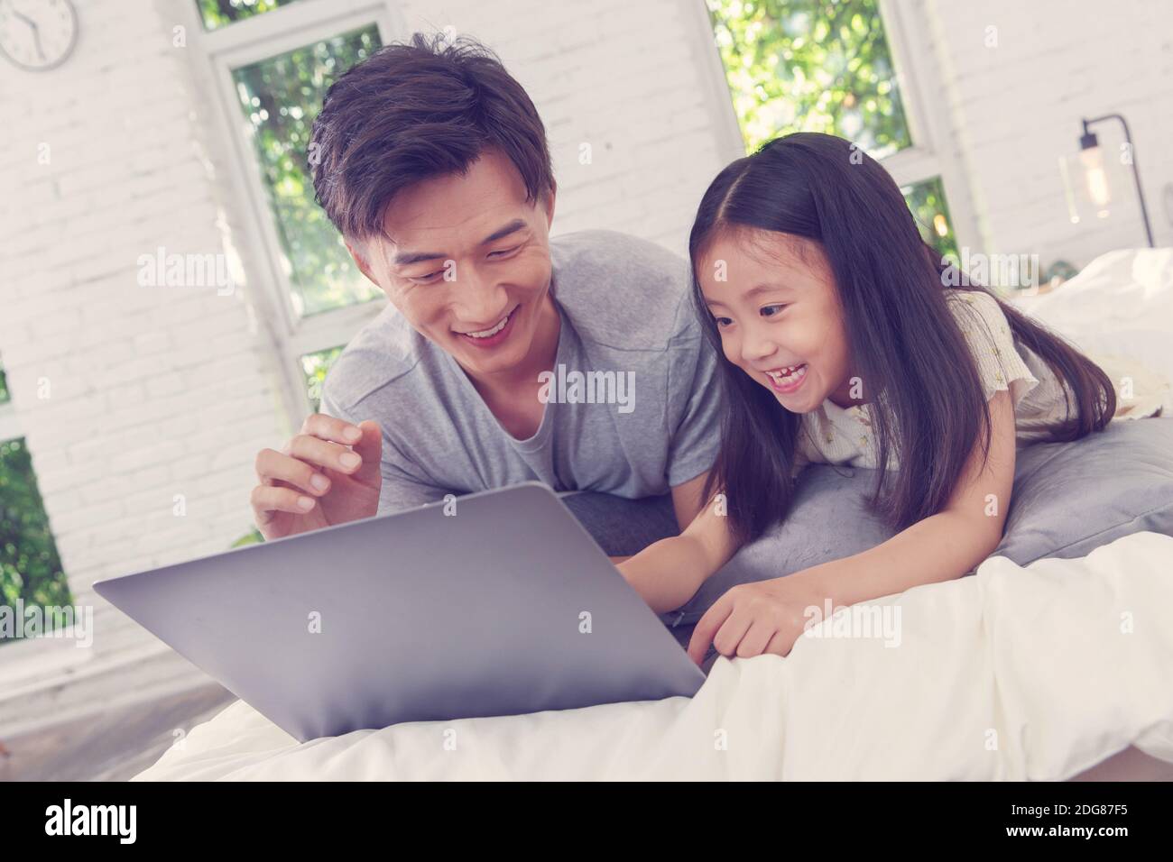 Happy together, father and daughter use the computer Stock Photo - Alamy
