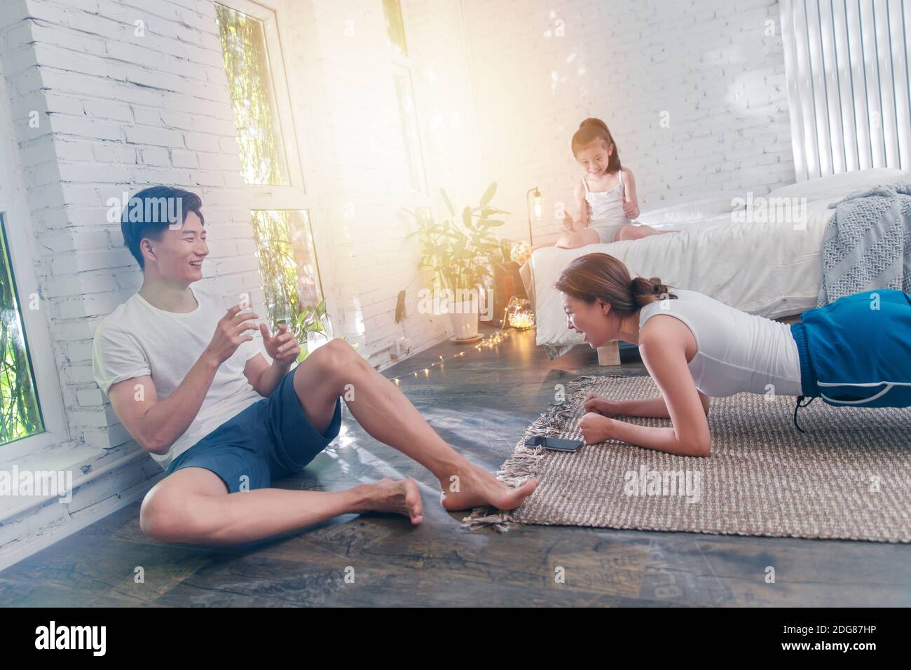 The happiness of a family of three inside the bedroom Stock Photo - Alamy