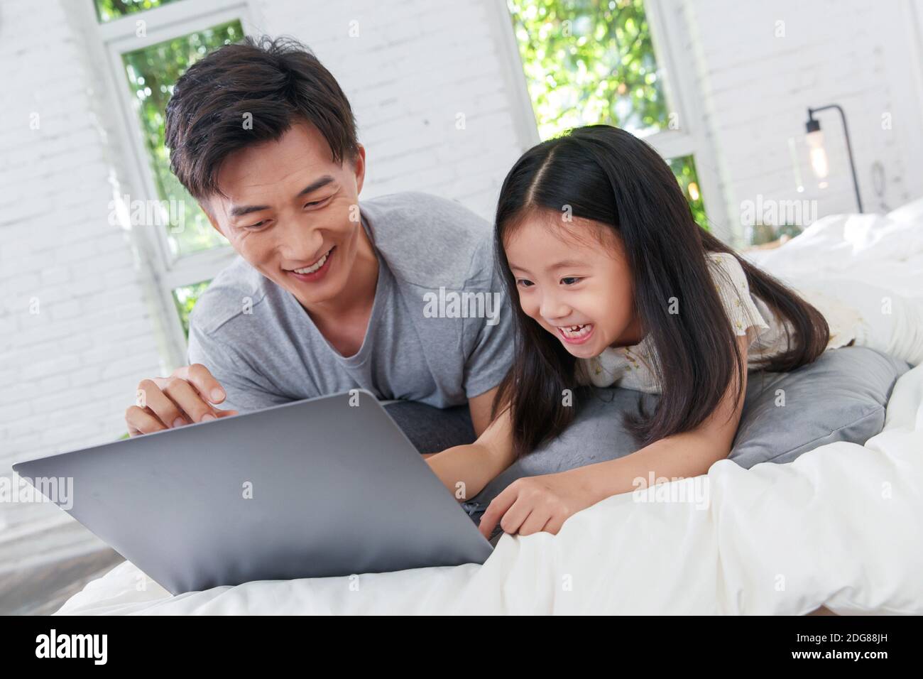 Happy together, father and daughter use the computer Stock Photo - Alamy