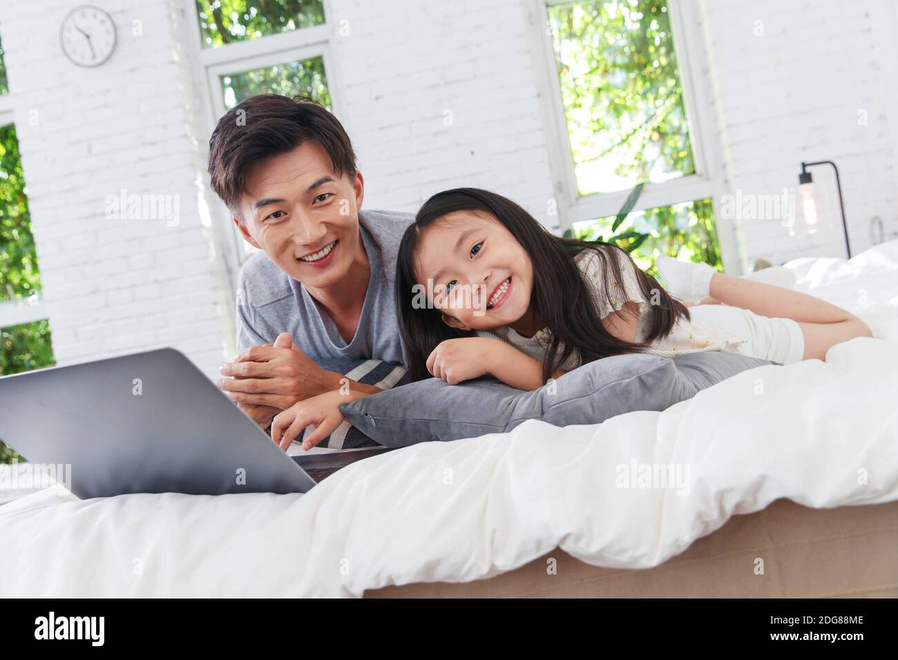 Happy together, father and daughter use the computer Stock Photo - Alamy