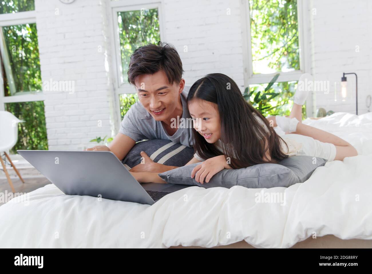Happy together, father and daughter use the computer Stock Photo - Alamy