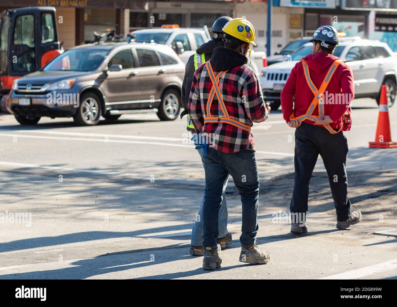 Construction workers on the street walking during lunch time. Selective ...