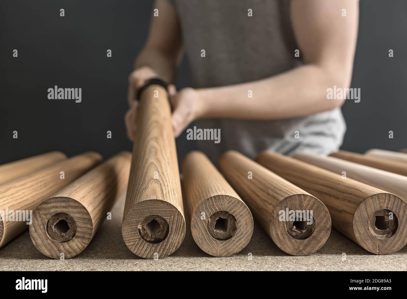 Man taking wooden billet Stock Photo - Alamy