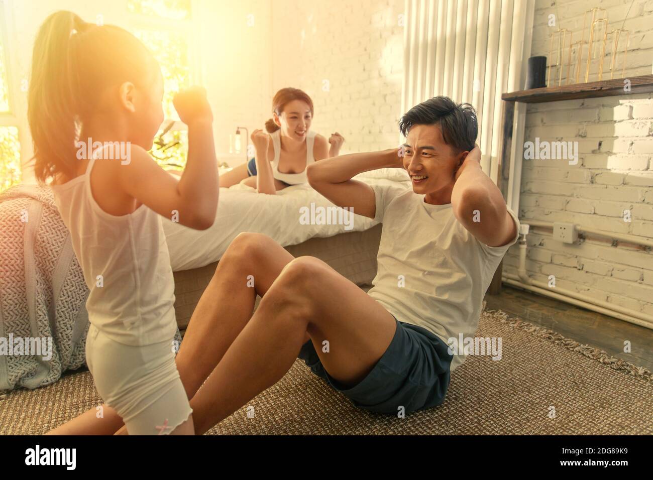A family of three happy movement inside the bedroom Stock Photo - Alamy