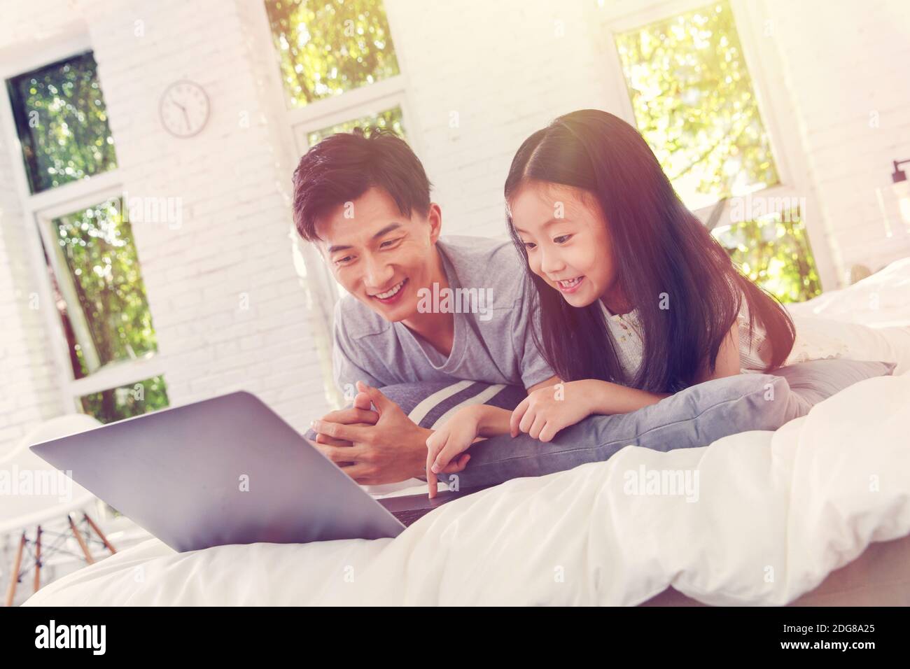 Happy together, father and daughter use the computer Stock Photo - Alamy