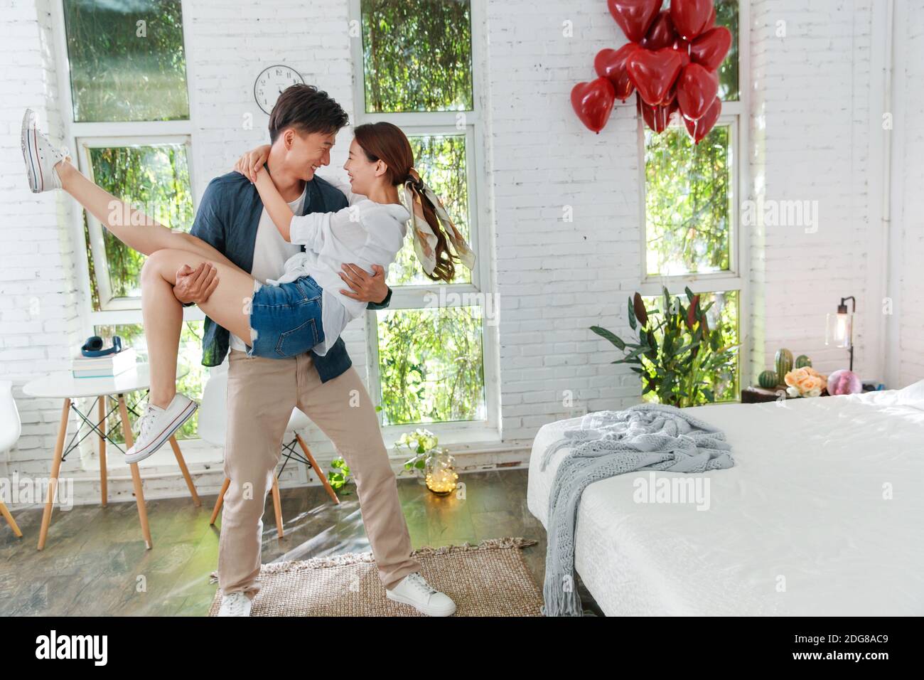 Happy young couples in the bedroom Stock Photo - Alamy