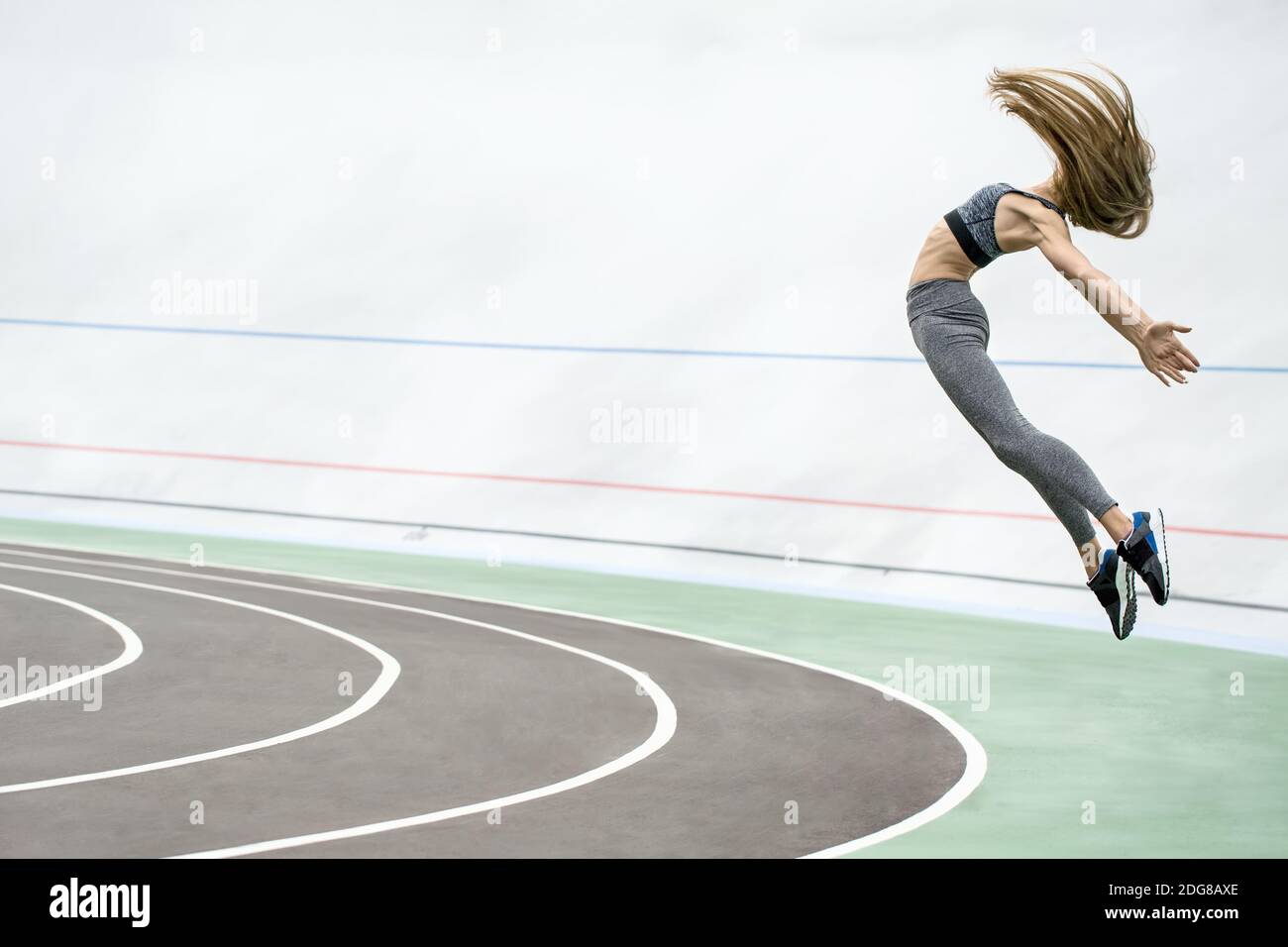 Sportive girl jumping outdoors Stock Photo - Alamy