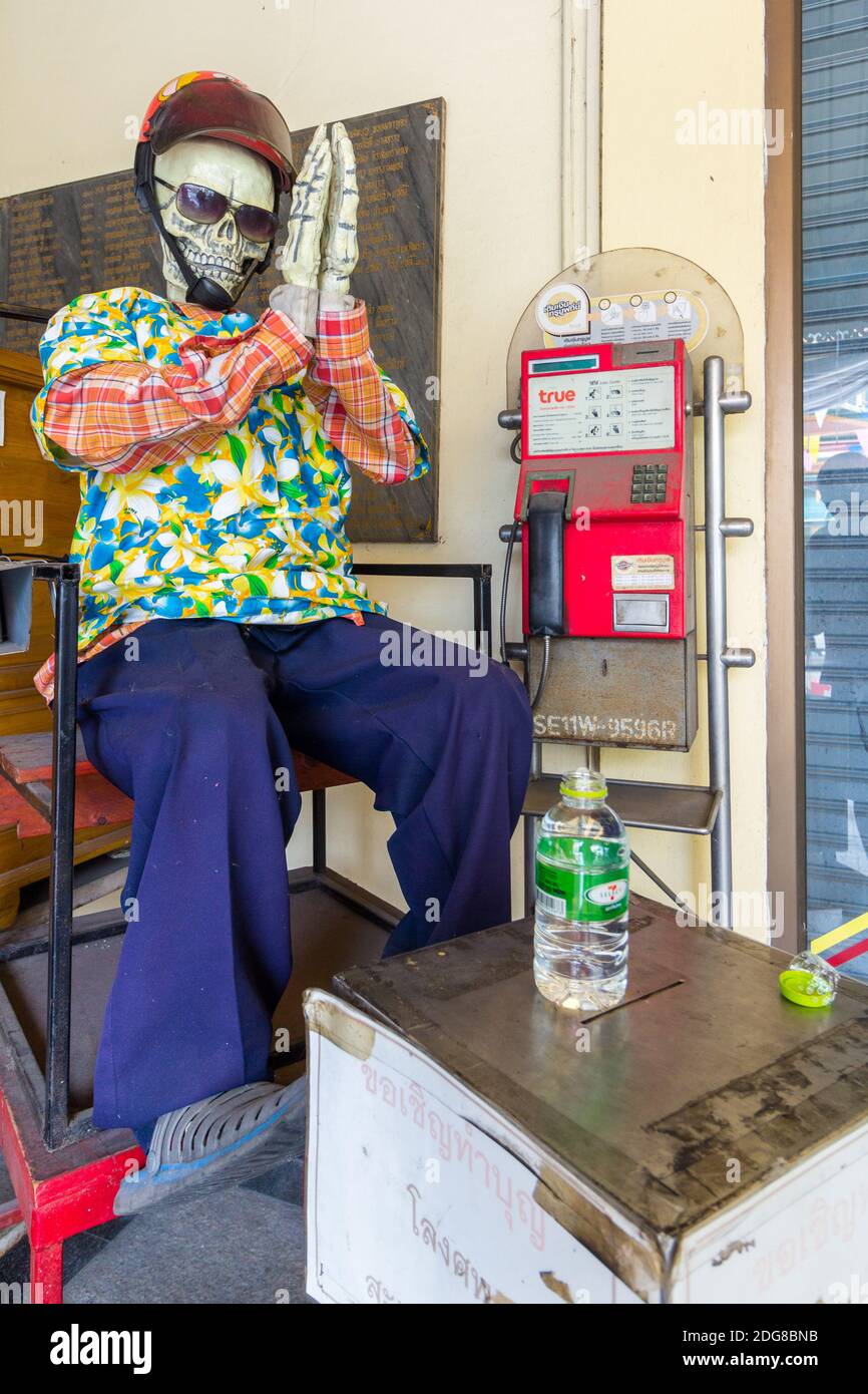 A dressed skeleton praying at a temple complex in Bangkok, Thailand ...