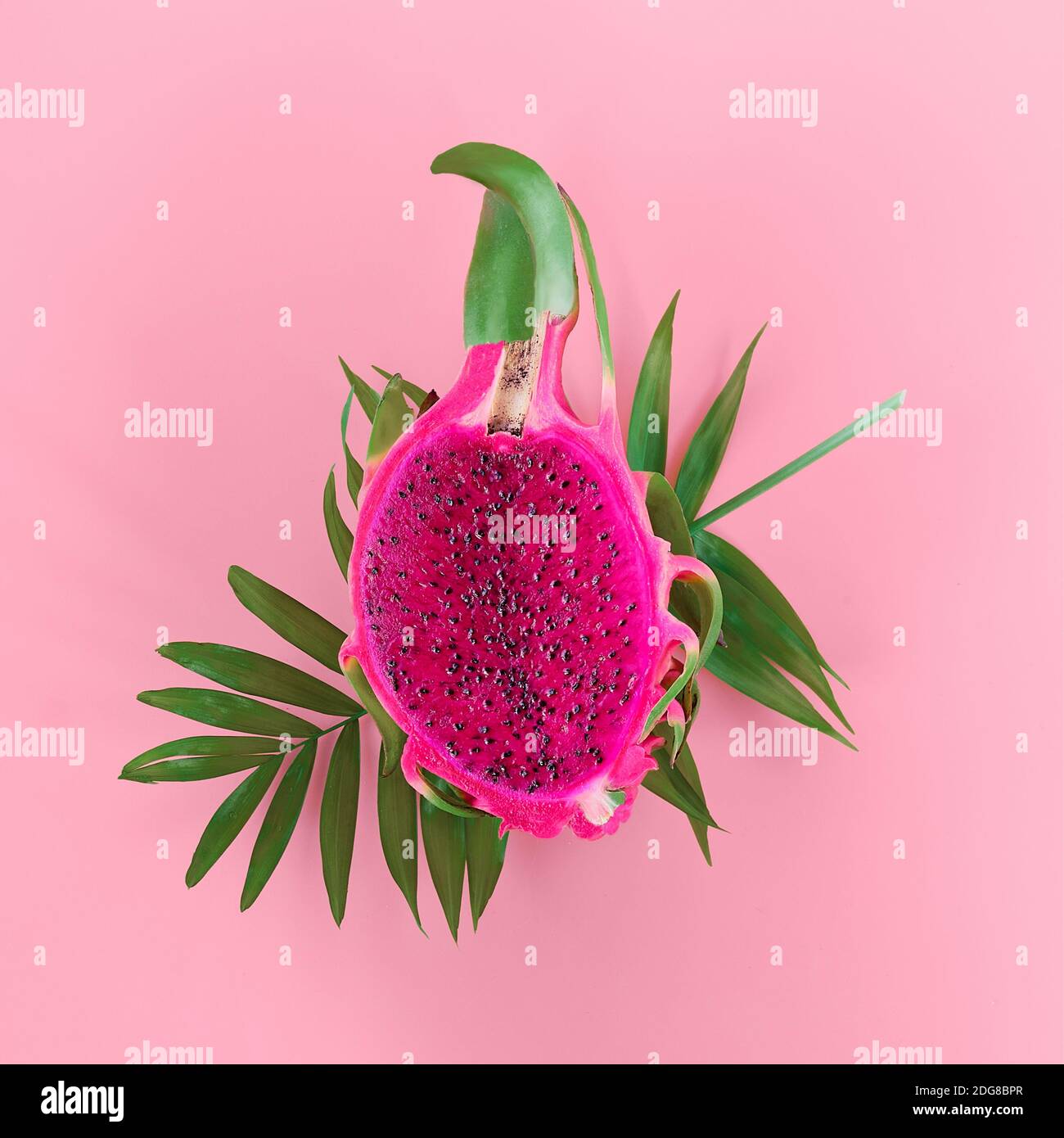 Fresh pink dragon fruit, pitaya or pitahaya, cut in half on pink ...