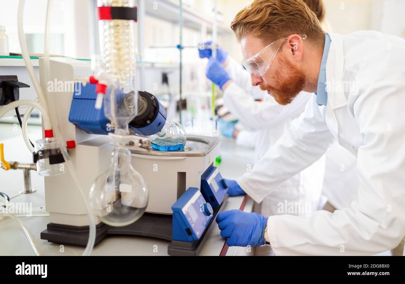 Research scientist looking at reaction in test tube in laboratory Stock ...