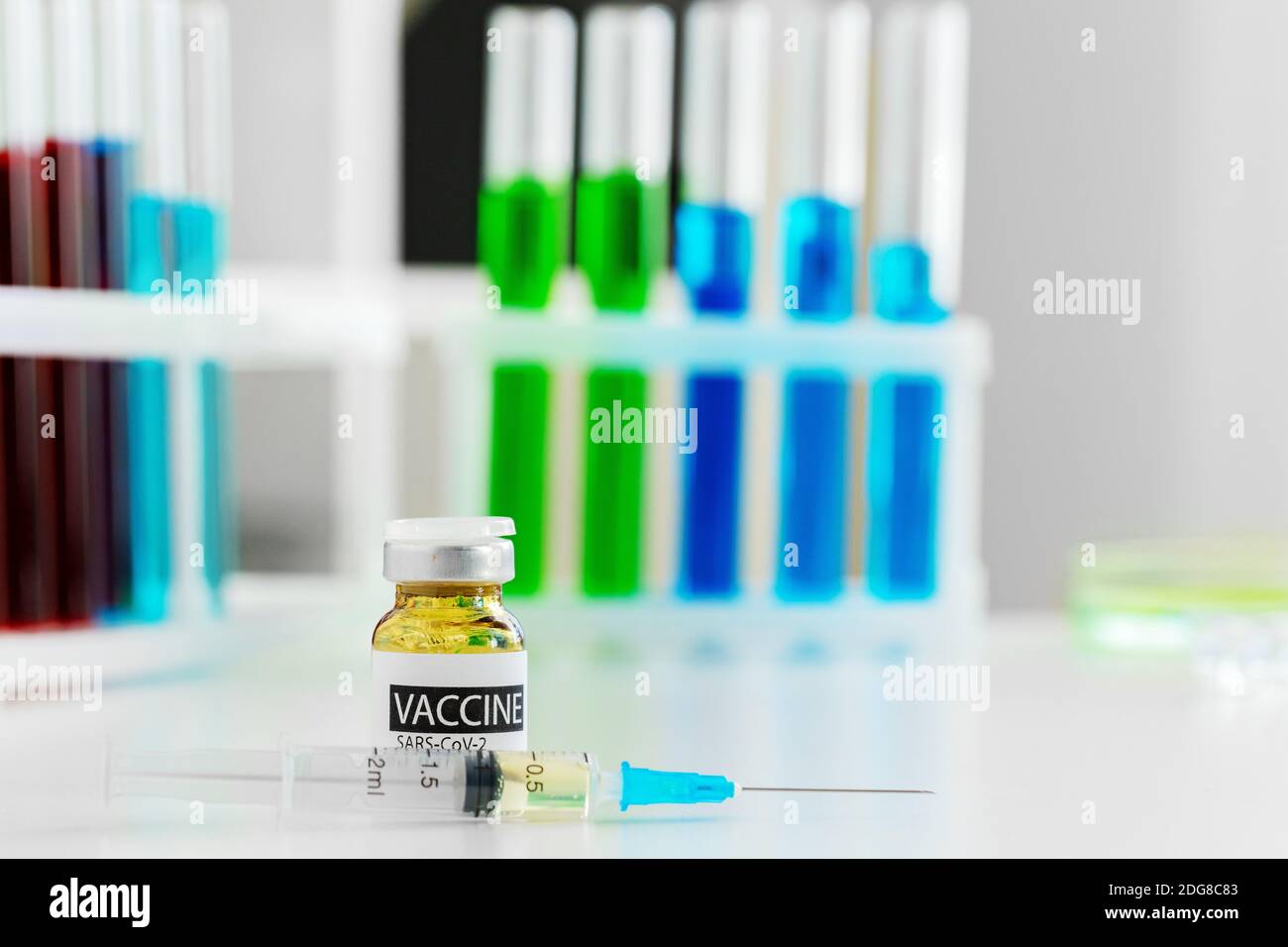 Vaccine in vial for injection on table against background of laboratory ...