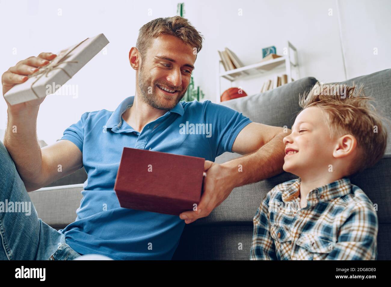 Little son gives his father a gift box for father's day Stock Photo - Alamy