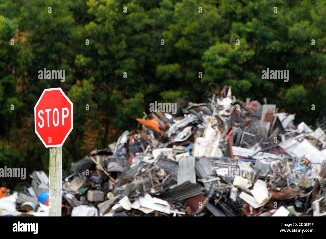 A red stop sign sends a message as it is positioned in front of a large ...