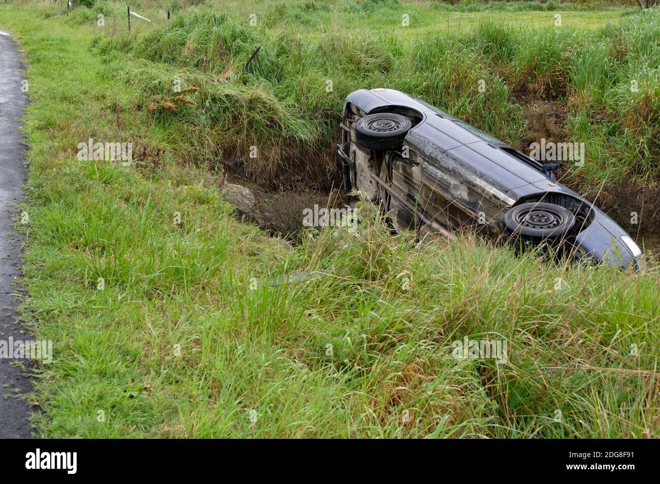 A car accident, the vehicle has left the road and is on its side Stock ...