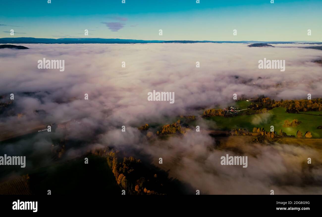 Heavy fog in a valley during sunrise Stock Photo - Alamy