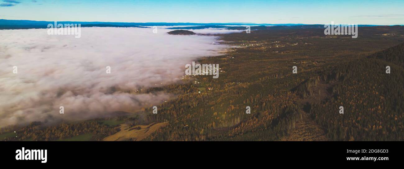 Heavy fog in a valley during sunrise Stock Photo - Alamy