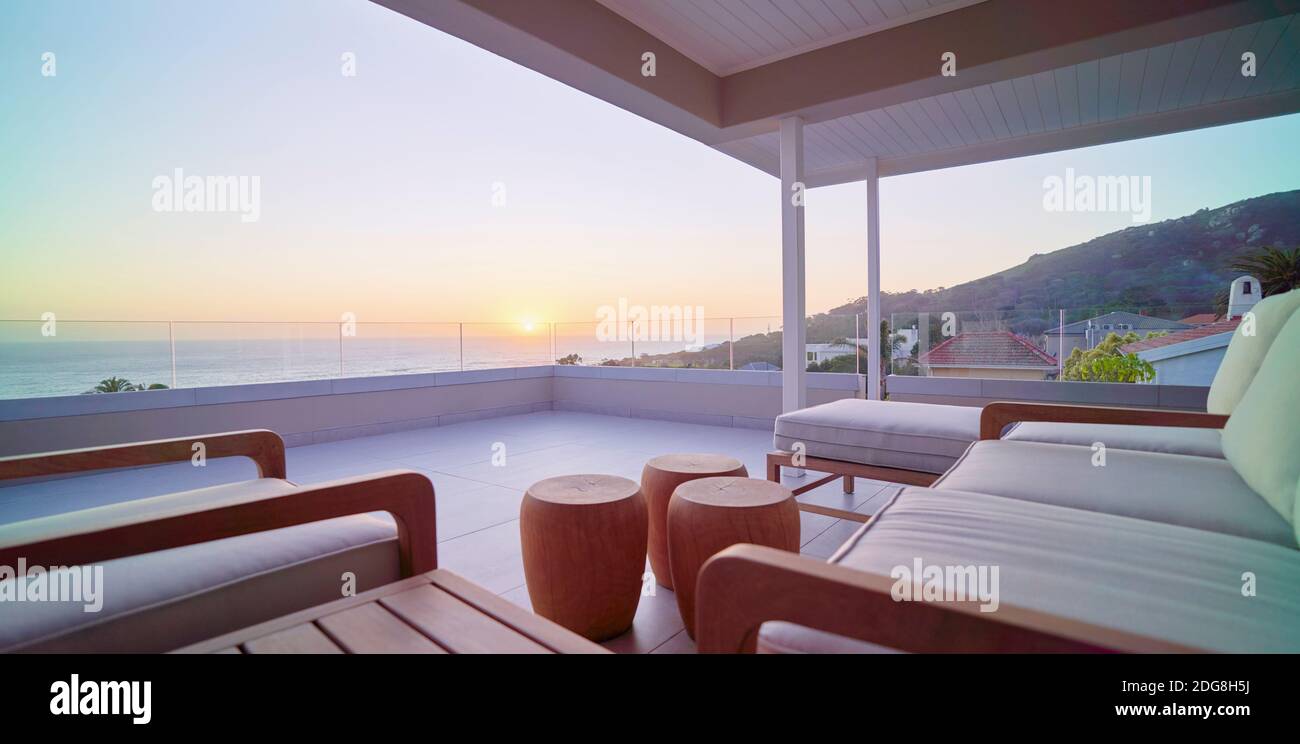 Scenic sunset ocean view from luxury home showcase balcony Stock Photo ...