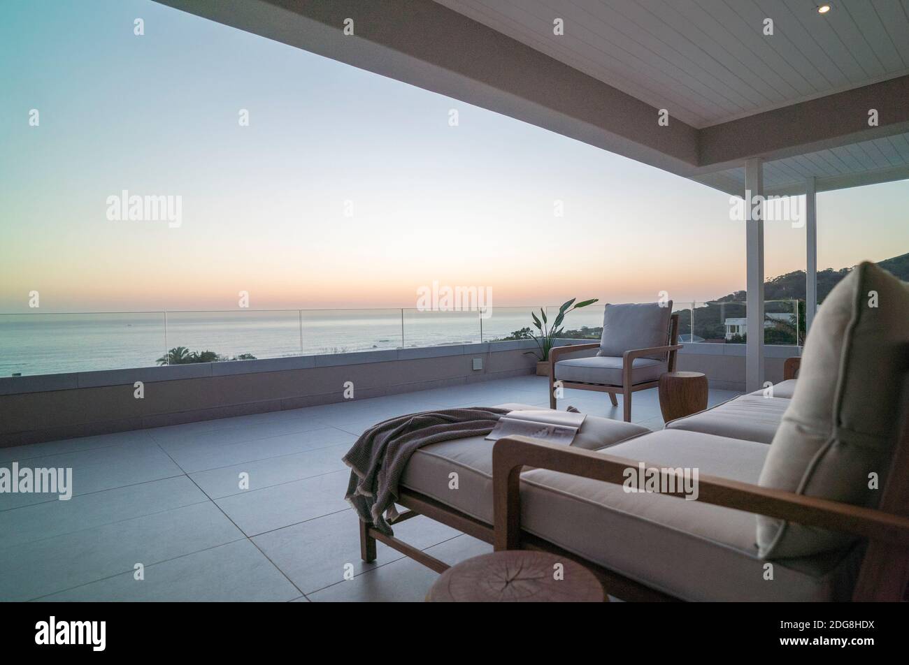 Luxury home showcase patio with scenic ocean view at sunset Stock Photo ...