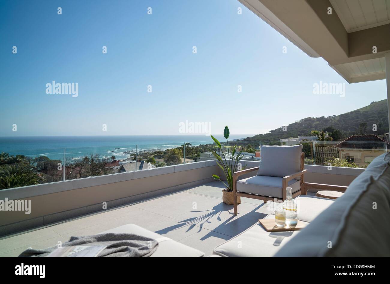 Sunny scenic ocean view from luxury home showcase balcony Stock Photo ...