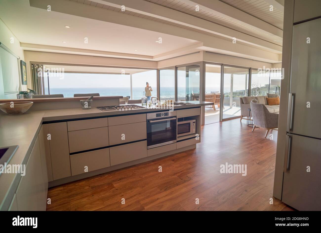 Modern home showcase interior kitchen with sunny ocean view Stock Photo ...