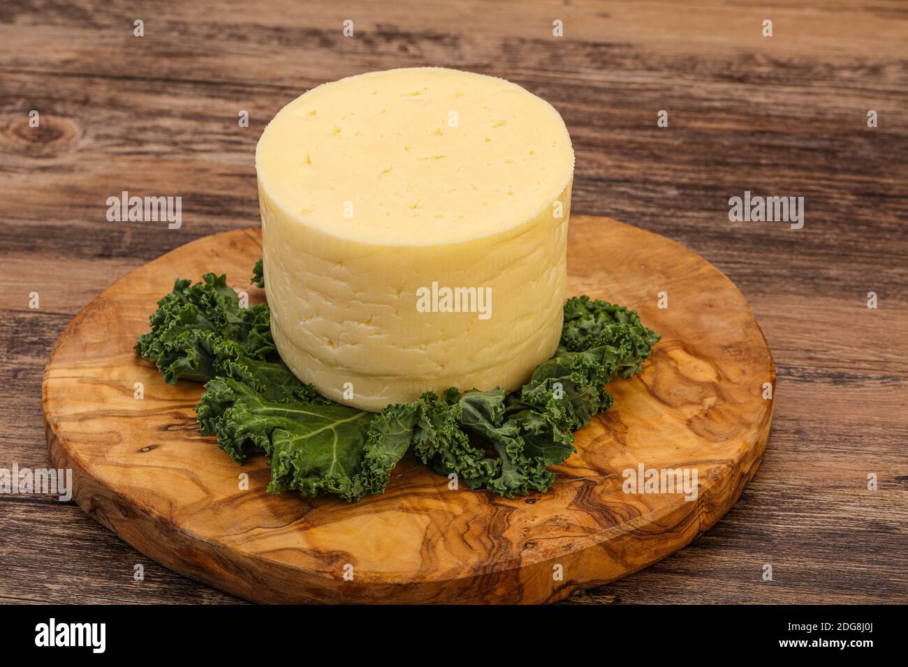 Yellow round dairy soft cheese piece Stock Photo - Alamy