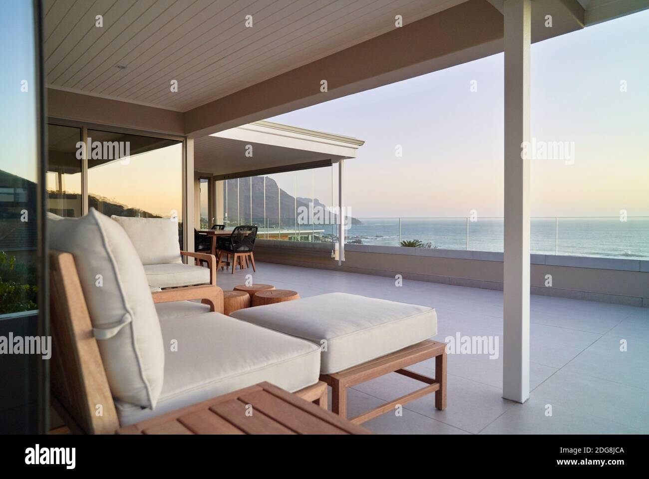 Luxury home showcase patio with tranquil scenic ocean view Stock Photo ...